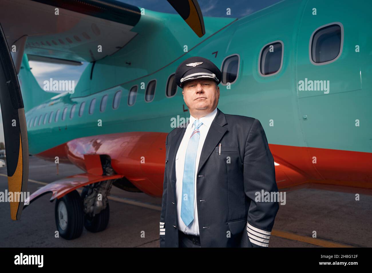 Professional airplane captain looking at camera near his plane Stock ...
