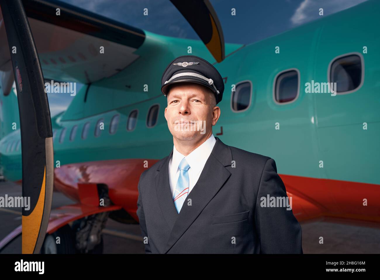 Pleased plane captain watching the camera outdoors Stock Photo - Alamy