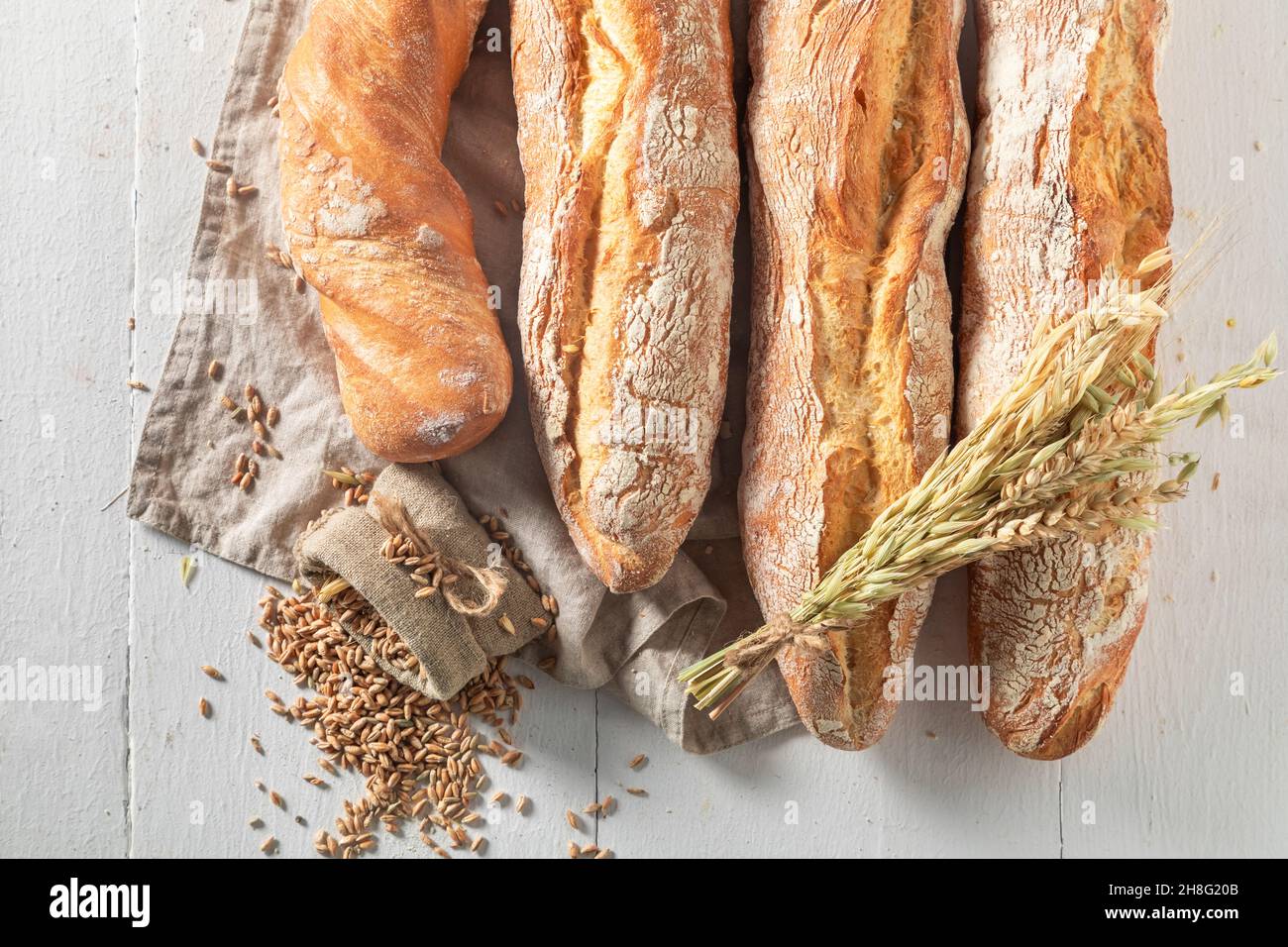 Rustic baguettes baked in bakery. Country kitchen or bakery. Pieces of ...