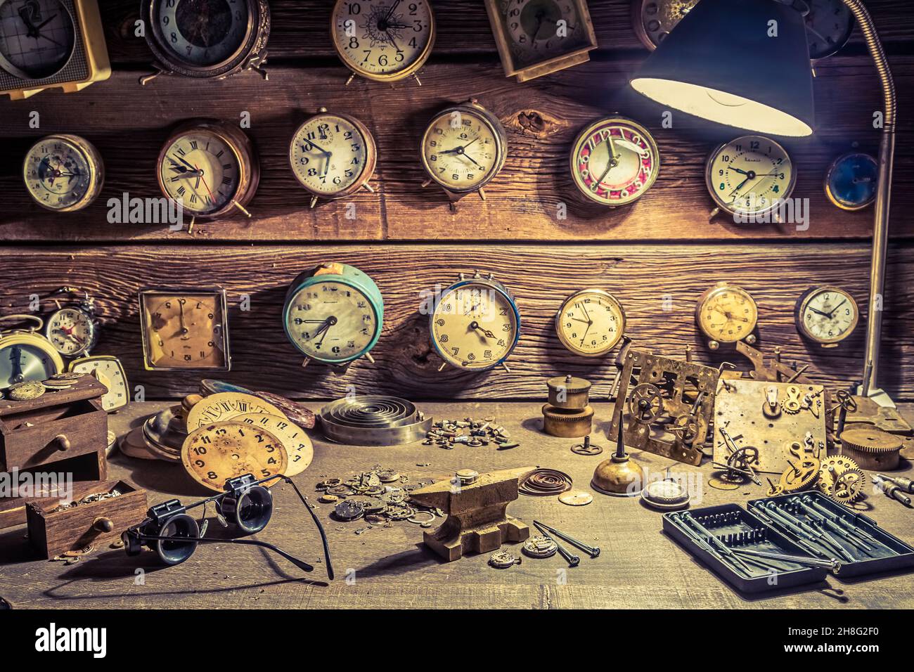 Old watchmaker's workshop with ruined clocks. Ancient watchmaker's ...