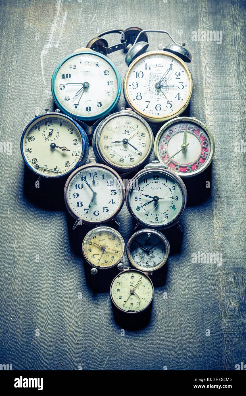 Mix of old clocks in pile. Parts of the old clock Stock Photo - Alamy