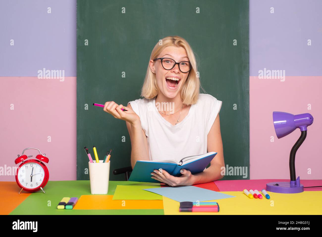 Shcool teacher in class on blackboard background. Professional portrait ...