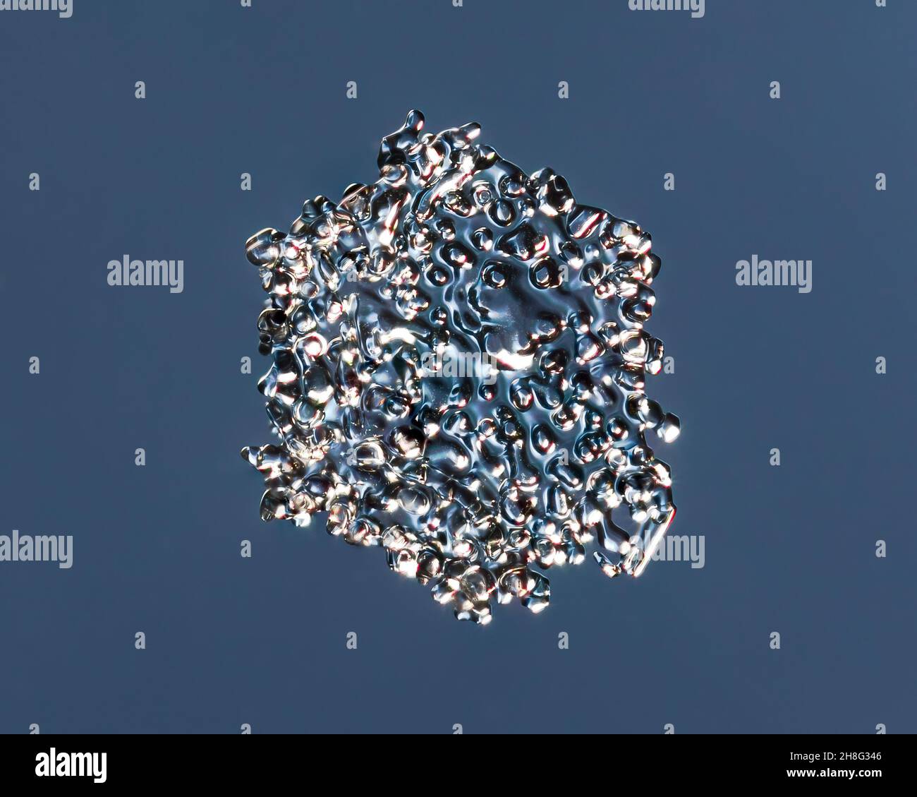 Real snowflake at high magnification. Macro photo of small snow bubbly ...