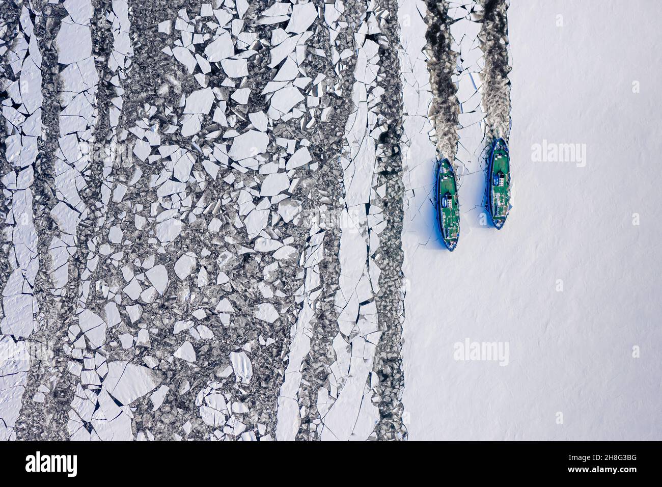 Two icebreakers on river crush the ice in Poland. Aerial view of nature ...