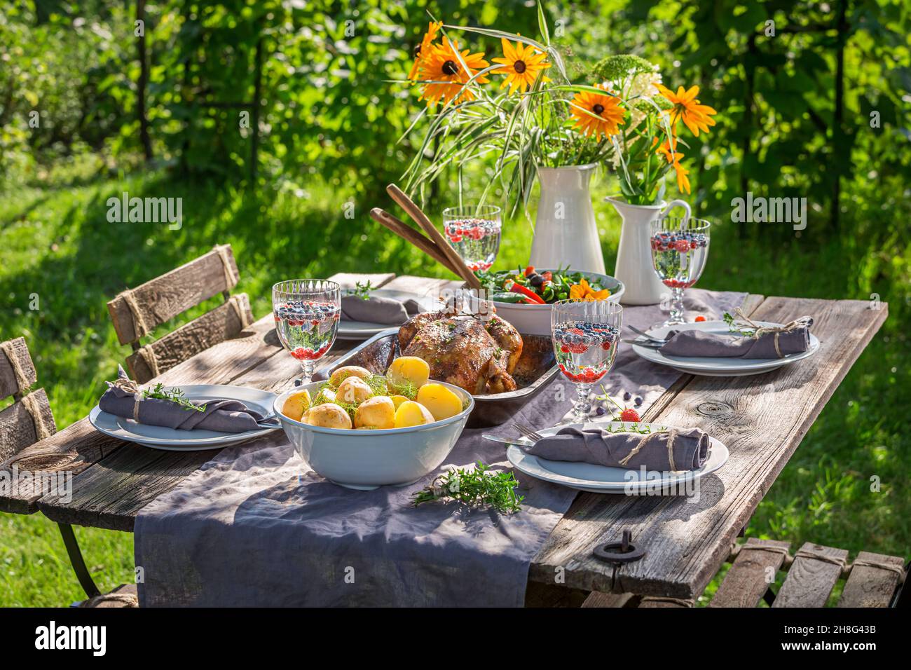 Tasty dinner with chicken served in garden. Dinner in garden. Homemade ...