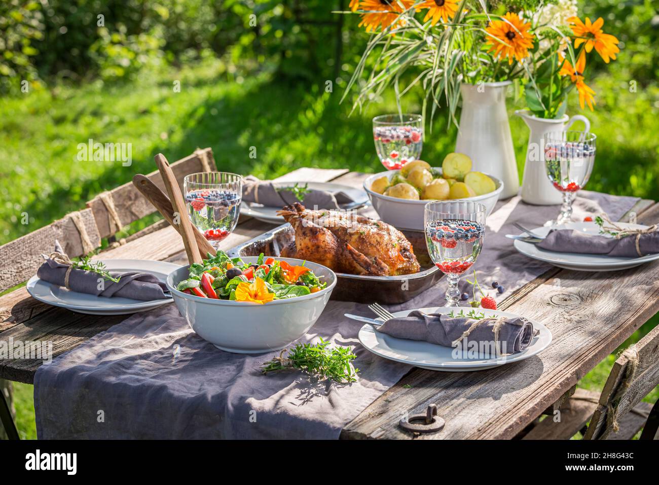 Homemade dinner with salad served in countryside. Dinner in garden ...