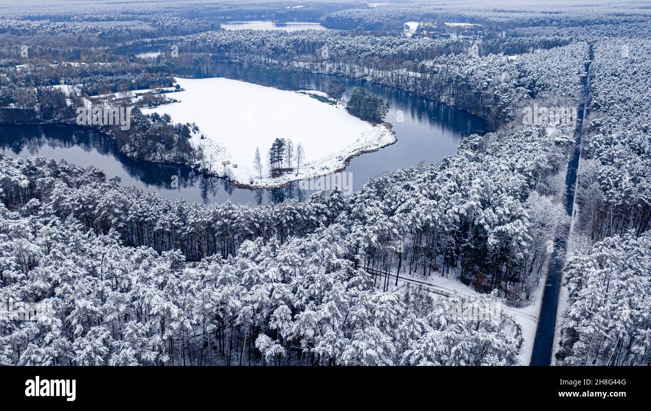 Cold winter river and snowy forest. Aerial view of wildlife in Poland ...