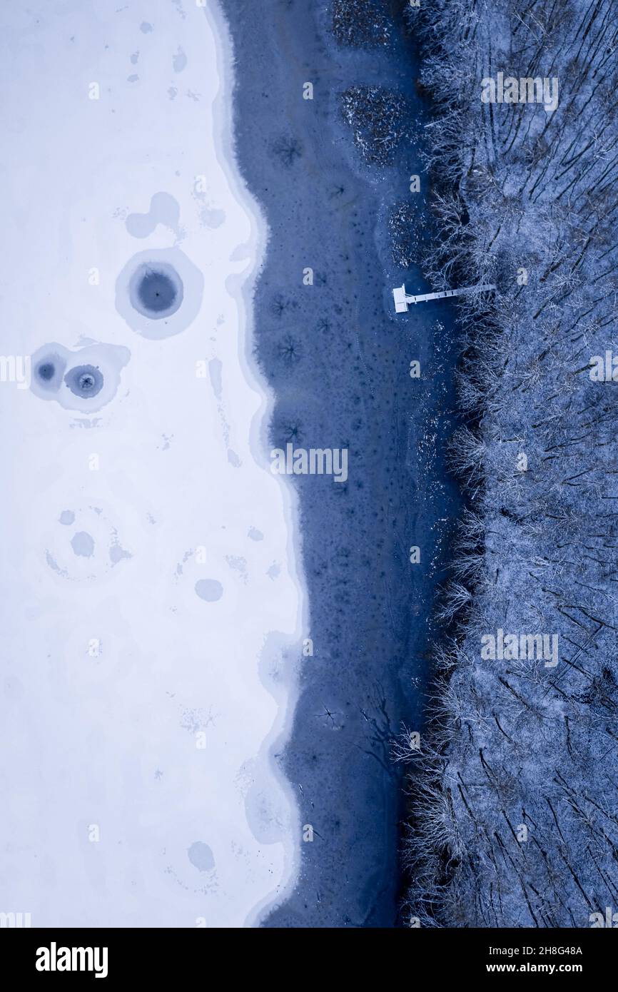 Ice holes and pier. Hobby in winter. Fishing on frozen lake. Aerial ...