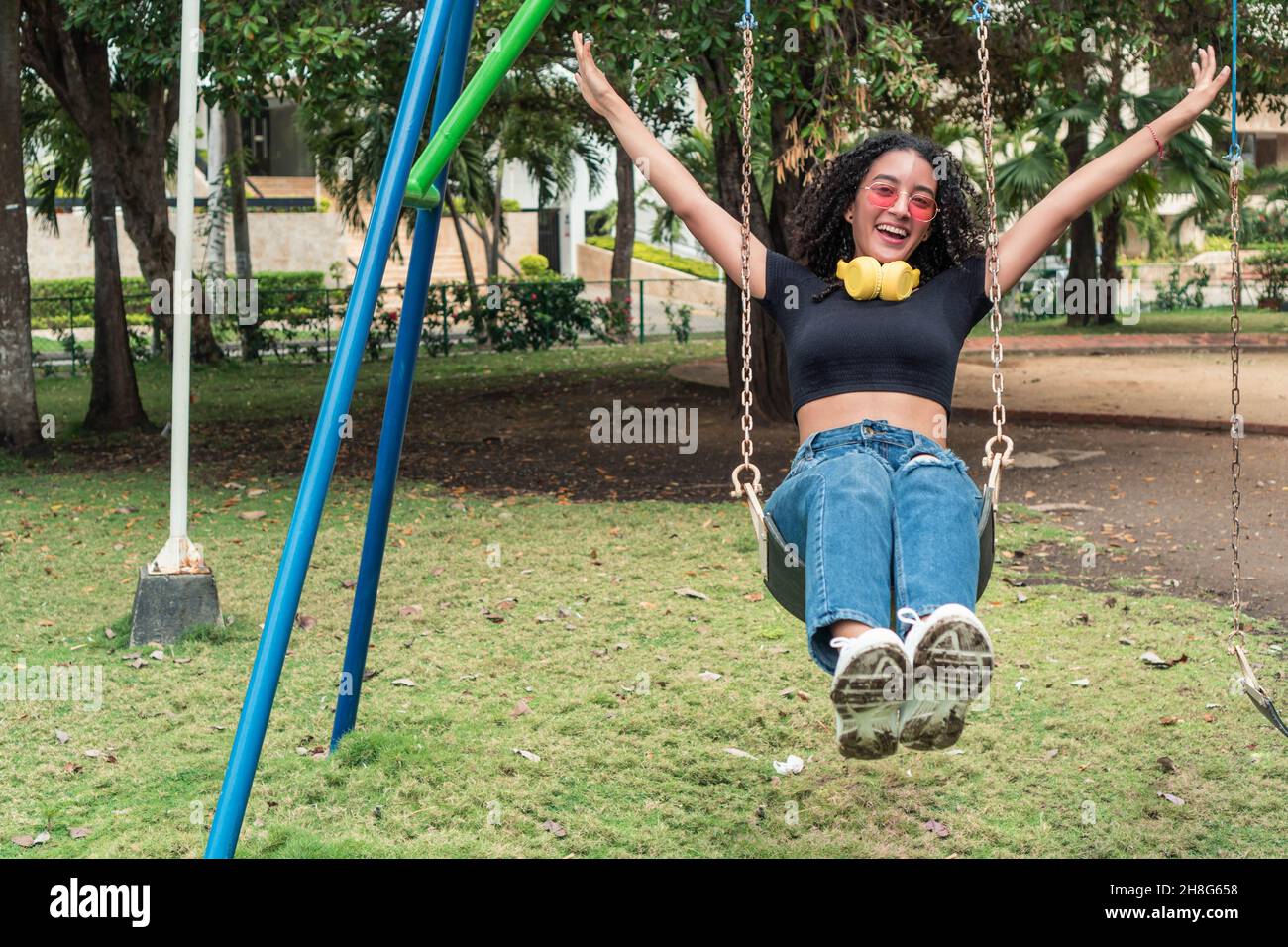 Latin Woman having fun in the park Stock Photo - Alamy