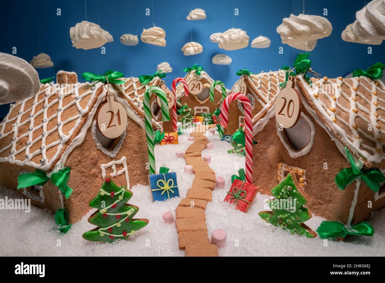 Homemade gingerbread cottages for Christmas with cookies, candies and ...