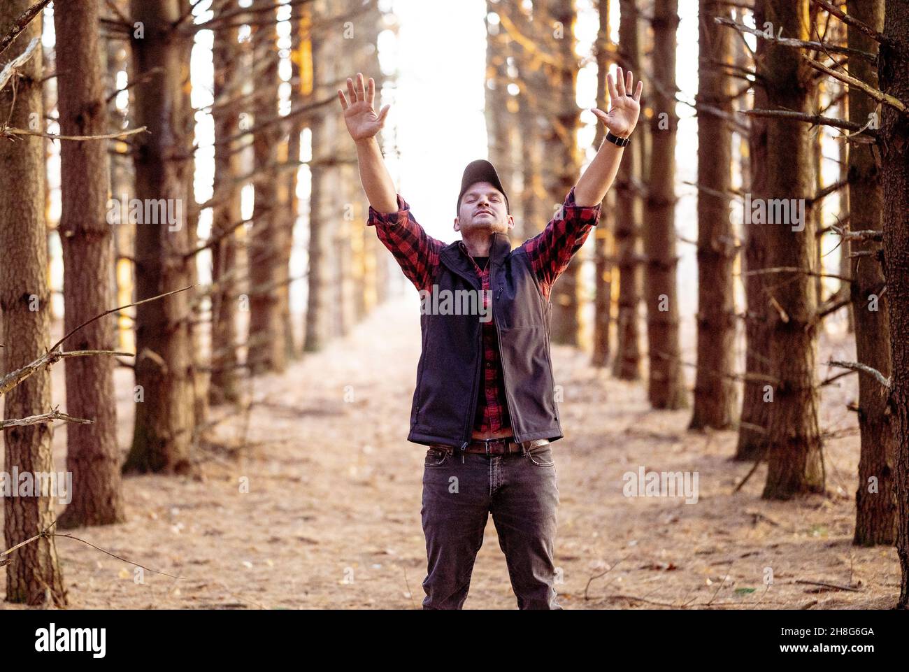 Caucasian man worshiping in prayer in the middle of the woods Stock ...
