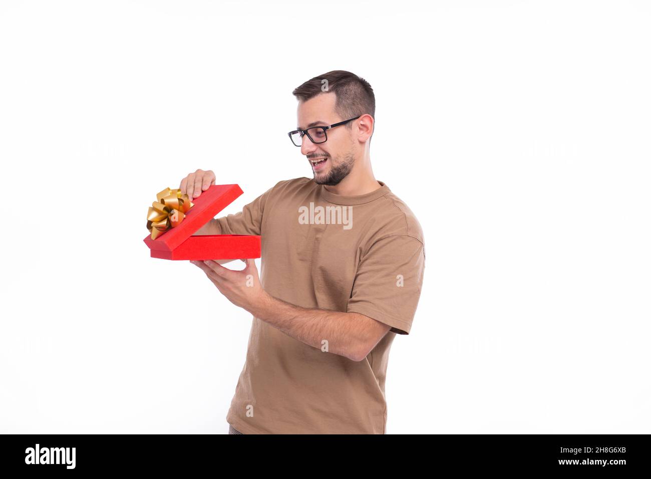 Man Holding Present Watching Whats inside. Man Holding Gift. Surprise ...