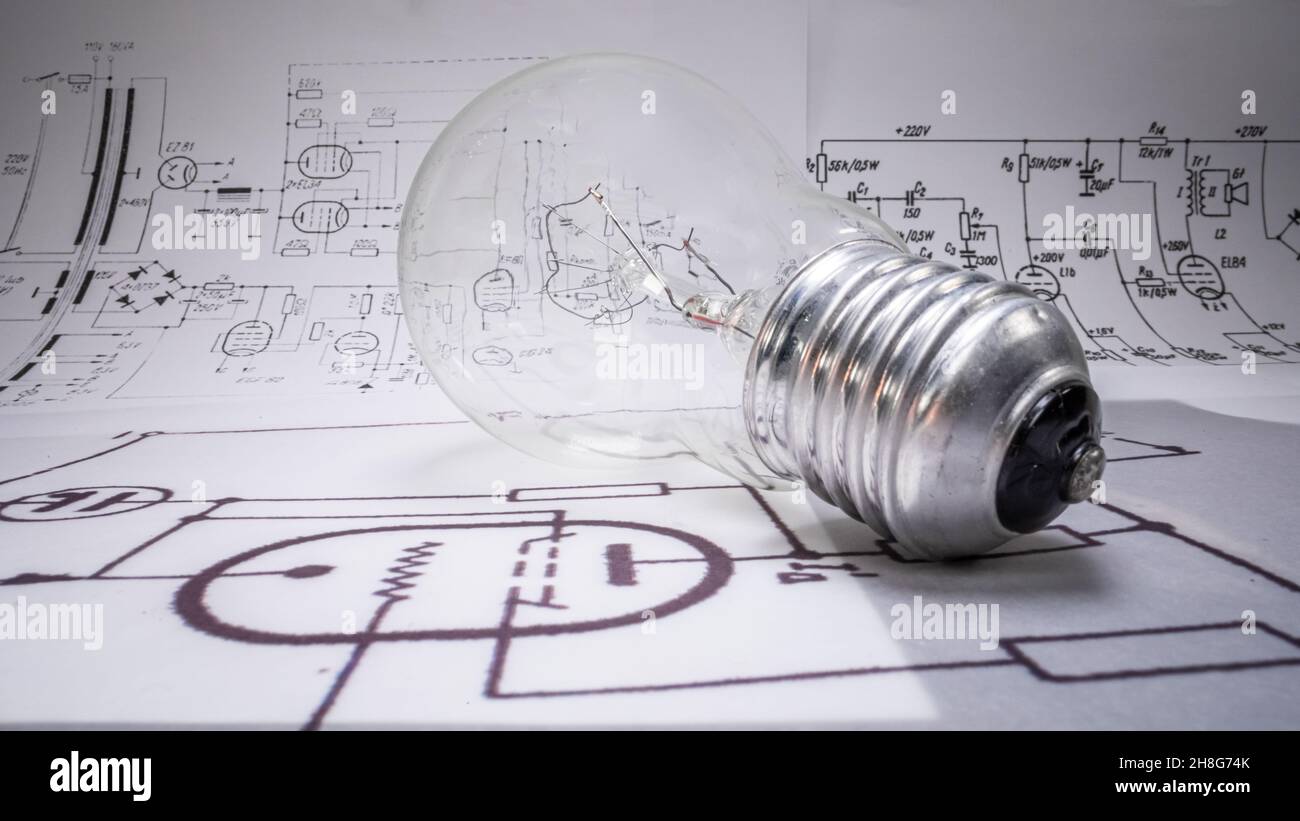 Closeup of light bulb with diagrams, fuses and cables. Old fashioned ...