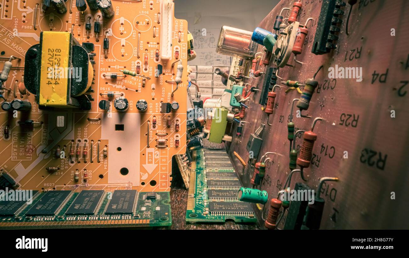 Vintage electronics workshop. with parts, soldering iron and voltmeter ...