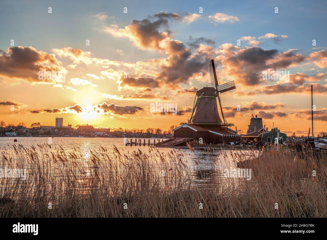Traditional Dutch windmills against colorful sunset in Zaanse Schans ...