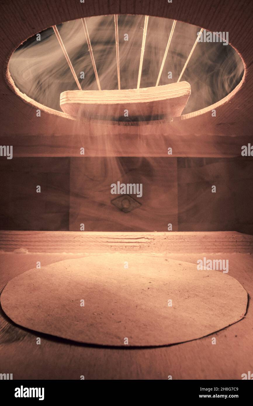 Interior of old guitar. Strings and guitar from inside. Macro view of a ...