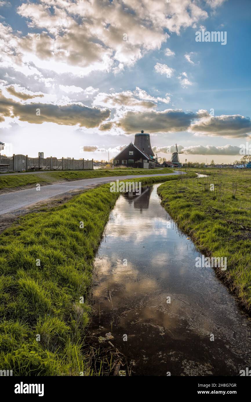 Traditional Dutch windmills against colorful sunset in Zaanse Schans ...