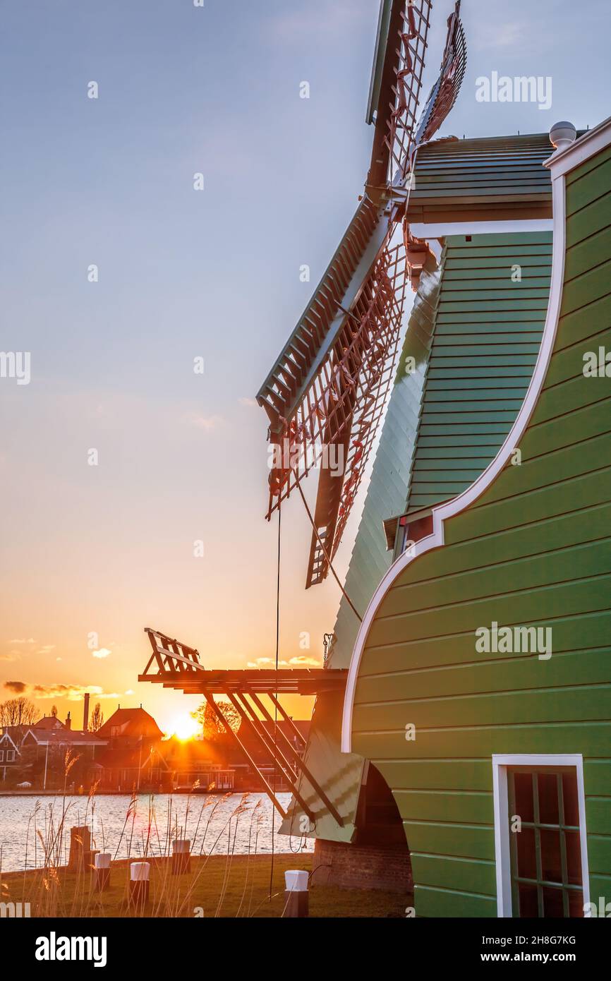 Traditional Dutch windmills against colorful sunset in Zaanse Schans ...
