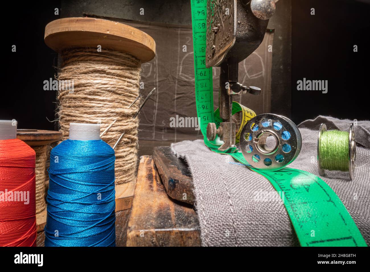 Vintage tailor workshop with tape measure and threads on spools ...