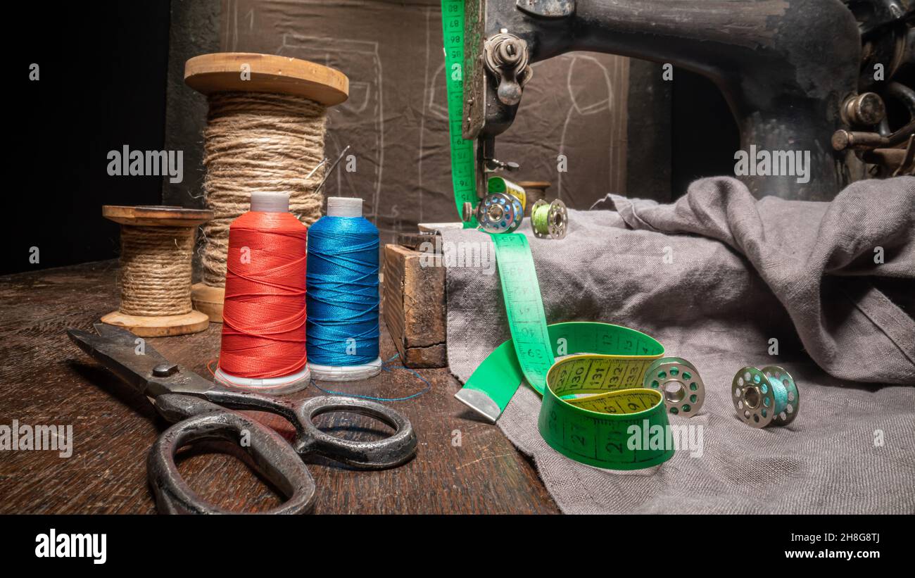 Old tailor workshop with tape measure and threads on spools. Vintage ...