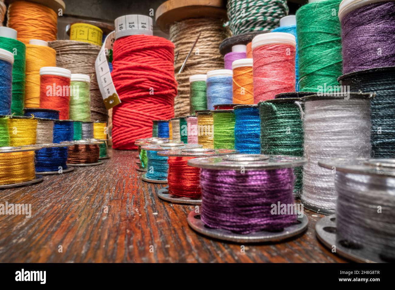 Small tailor workshop with tape measure and threads on spools. Vintage ...