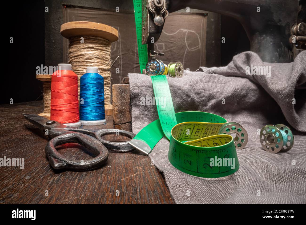 Antique tailor workshop with tape measure and threads on spools ...