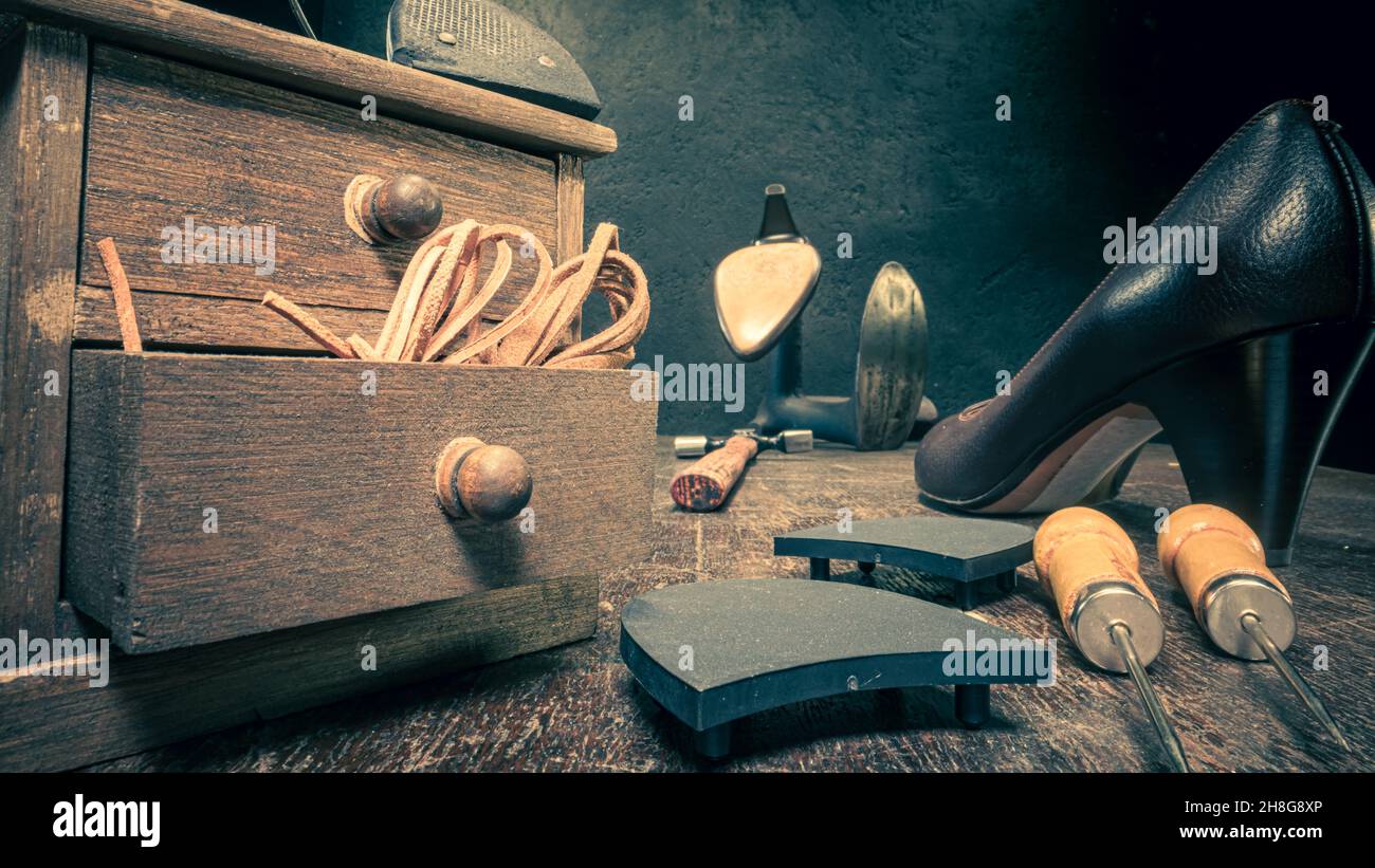 Traditional shoemaker workshop with tools, strap, leather and rules ...
