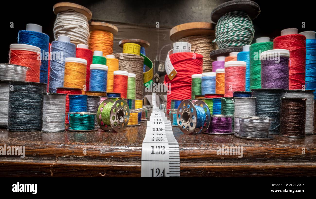 Small tailor workshop with scissors and sewing machine. Vintage weaving ...