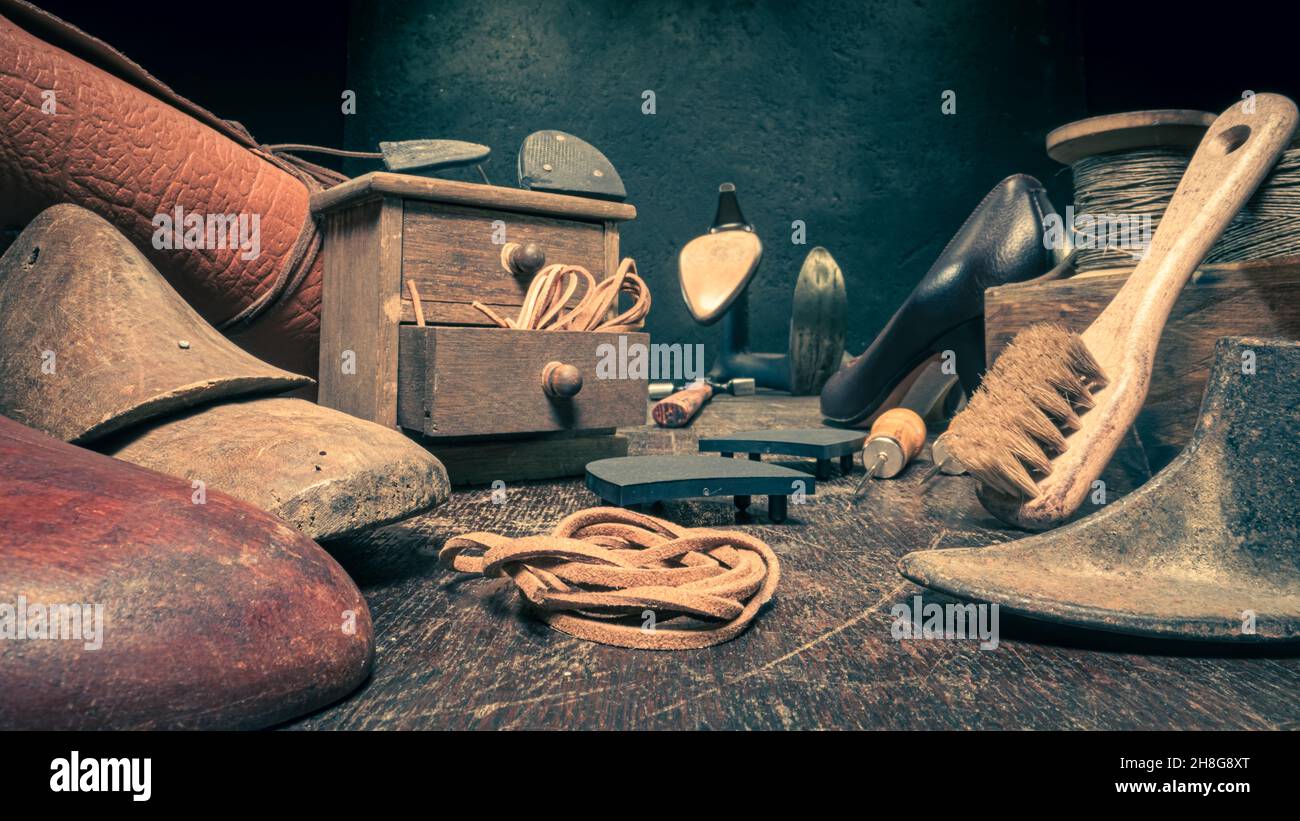 Antique shoemaker workshop with tools, laces and shoes. Antique ...