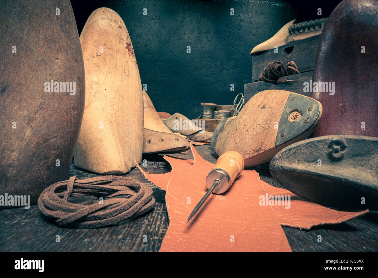 Old cobbler workplace with tools, strap, leather and rules. Old cobbler ...