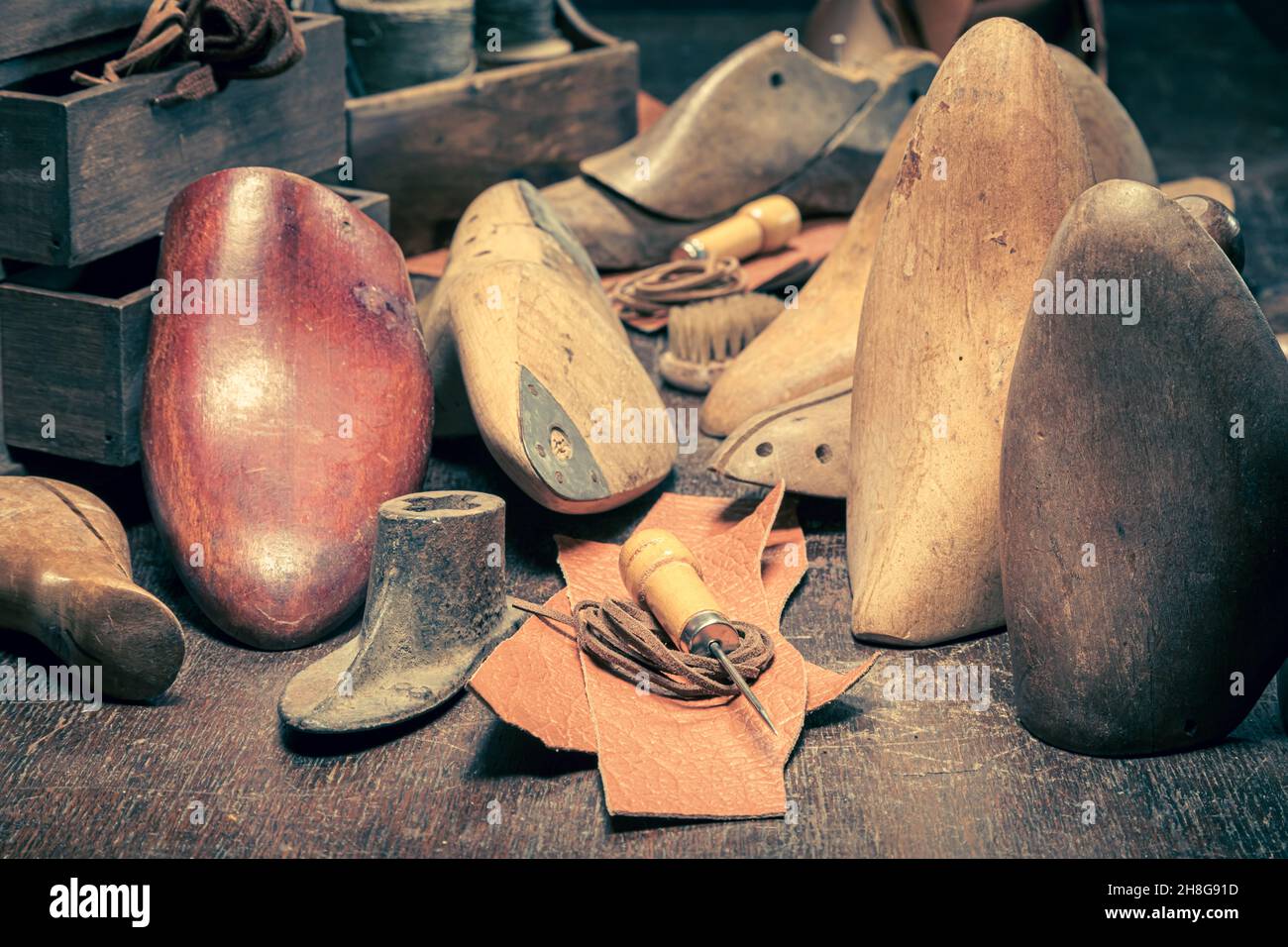 Vintage cobbler workplace with tools, rules, leather and strap. Vintage ...