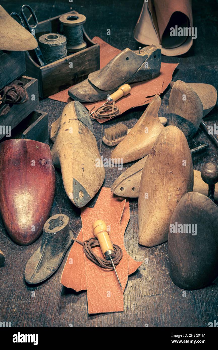 Old cobbler workplace with tools, rules, leather and strap. Old cobbler ...