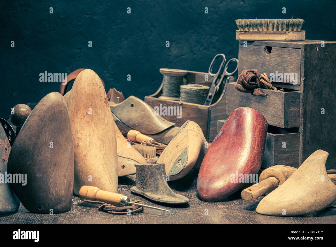 Vintage shoemaker workshop with tools, laces and shoes. Vintage ...