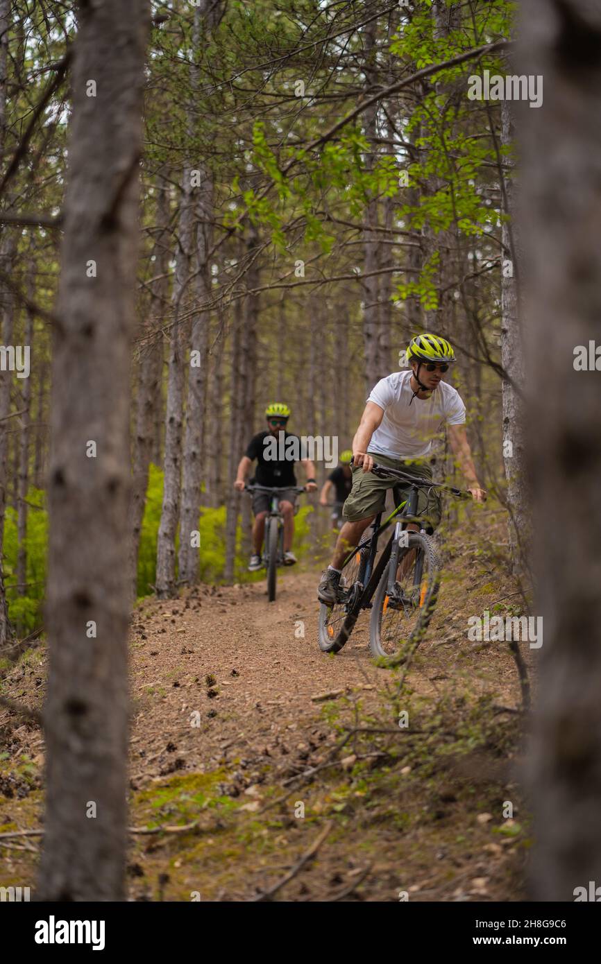 Group of friends are riding their bike in the forest while going in a ...