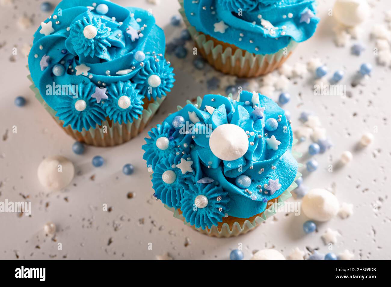 Sweet cupcakes with blue whipped cream ready to eat. Perfect blue ...