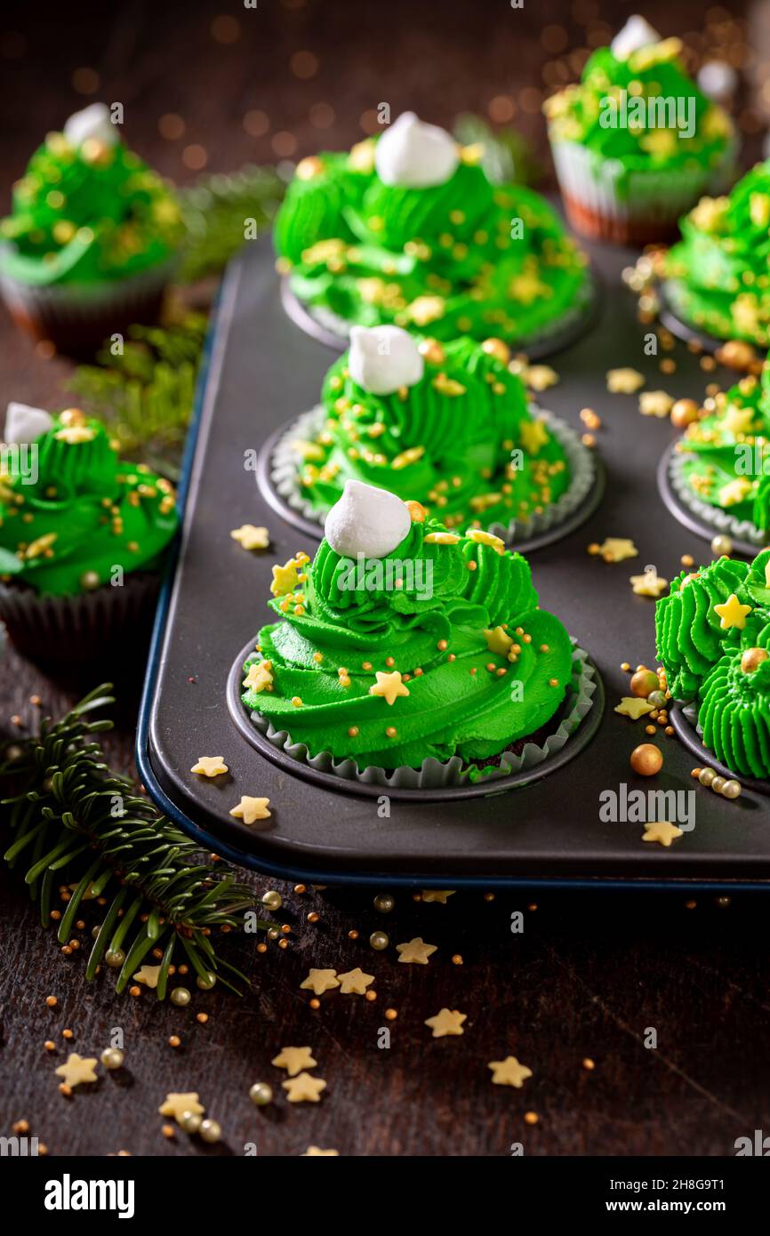 Sweet green cupcakes made of mint cream for fat thursday. Dessert for ...