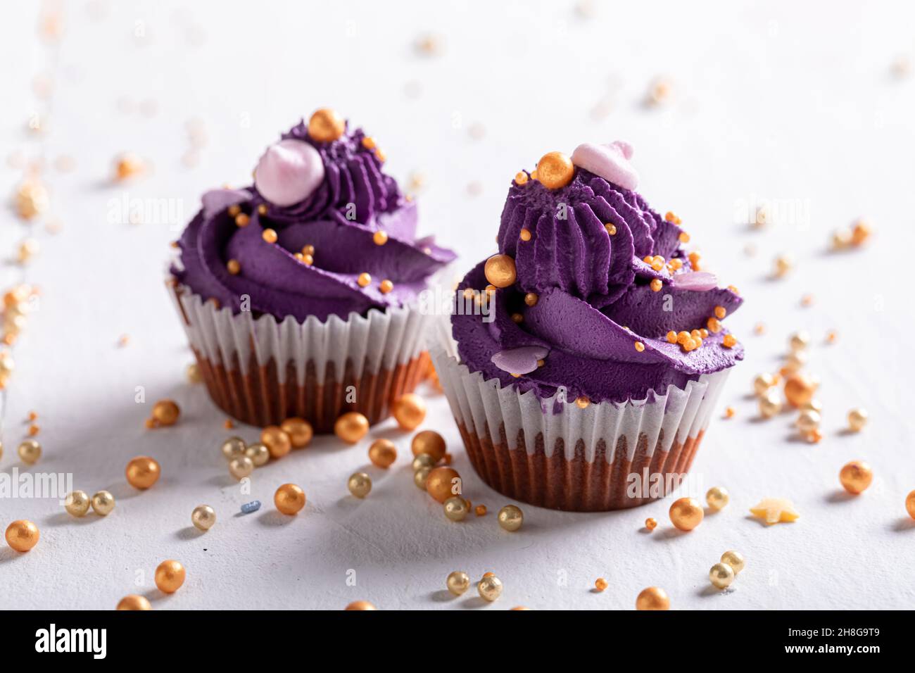 Cupcakes made of sprinkles and purple whipped cream. Purple dessert ...