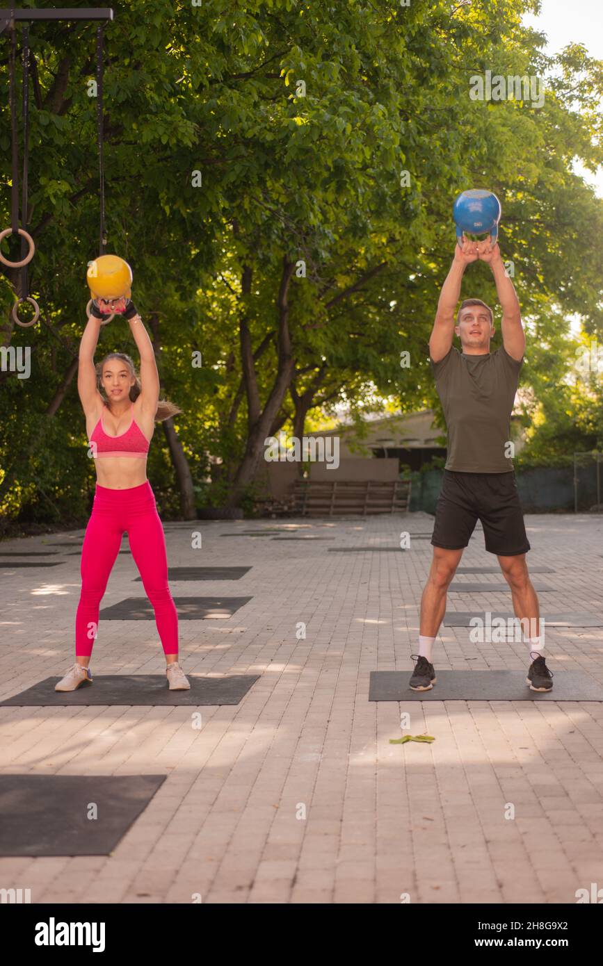 Beautiful and sweet couple is soing a exercise for the arms together ...