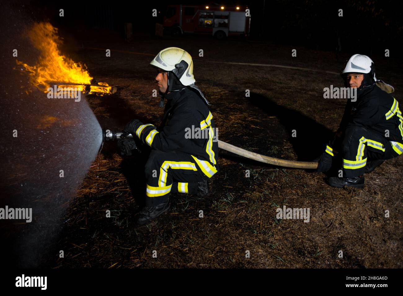 Firemen wearing protective gear during a firefighting intervention ...