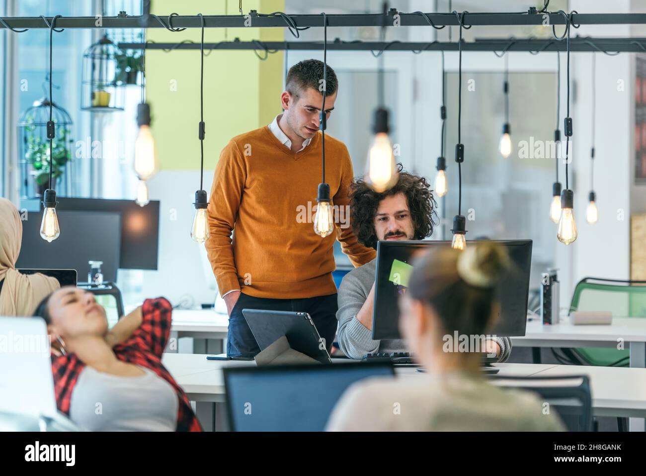 Portrait of two busy colleagues working on pc economy project on modern ...