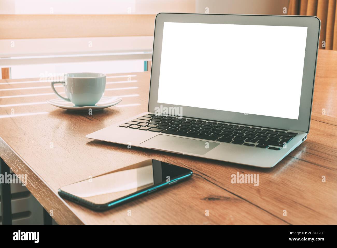 Laptop computer blank empty mock up screen in home office interior, working from home concept ...