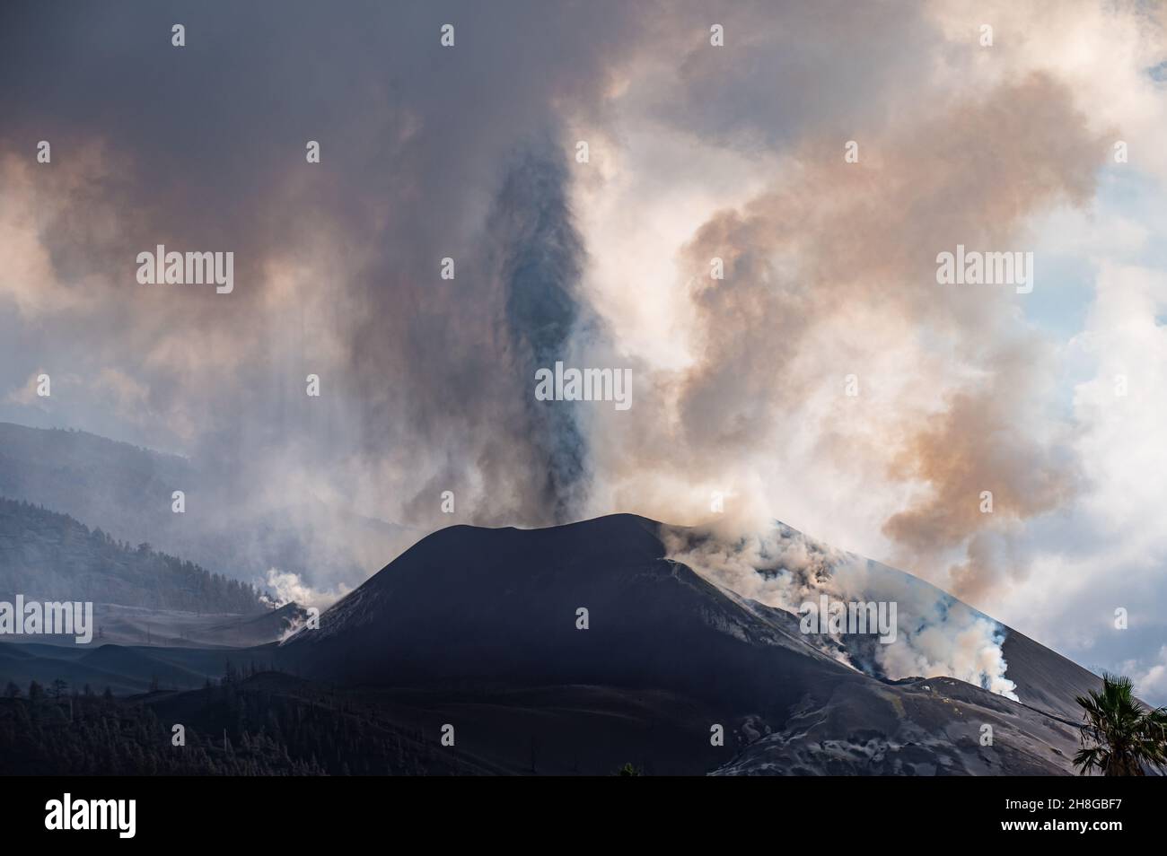 Active volcano with thick smoke erupting in daytime Stock Photo - Alamy