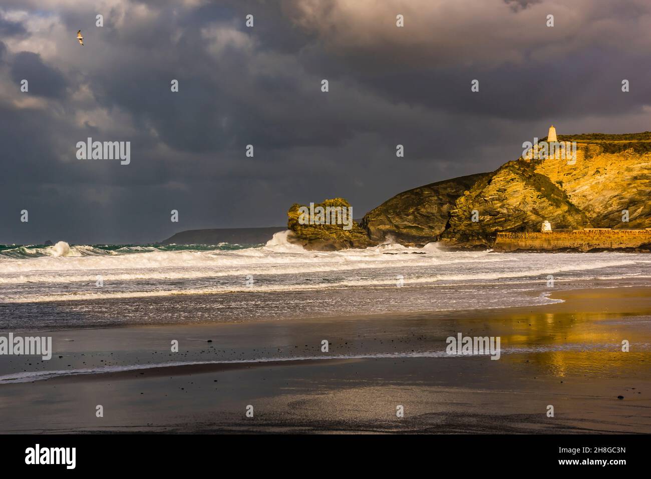 Surf against the harbour wall and rocks as Storm Arwen builds at ...