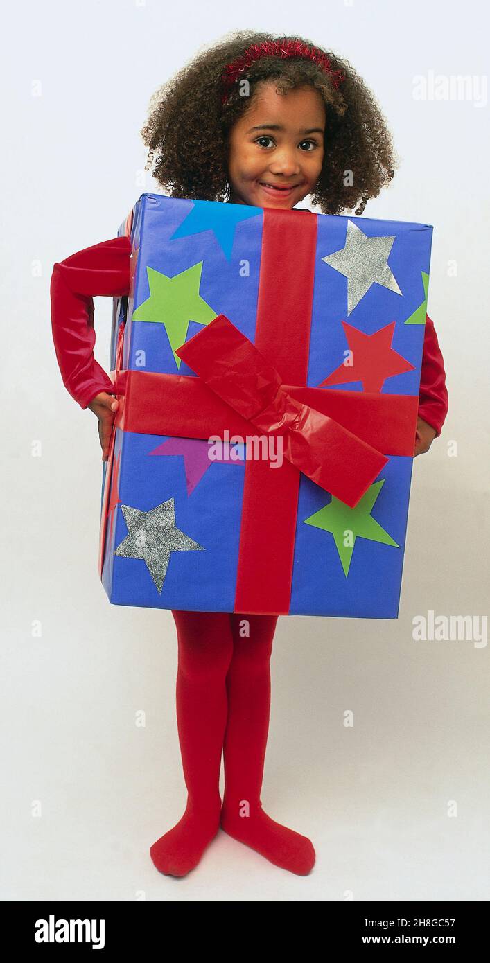 A girl wearing a gift wrapped cardboard box Stock Photo - Alamy