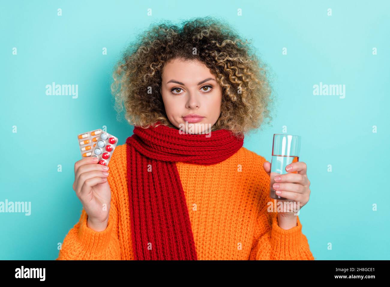 Photo of annoyed ill lady hold pills water glass wear scarf knitted ...