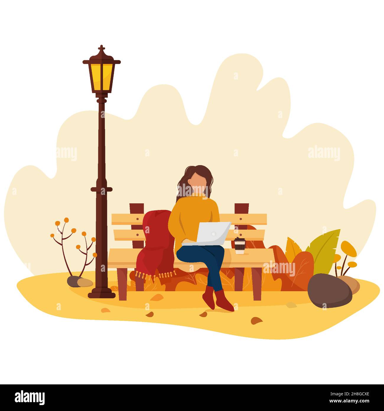 A girl sits on a bench in an autumn park and works at a laptop. Trend ...