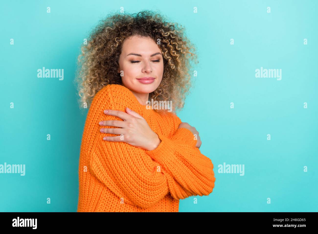 Photo of tender nice lady hands cuddle shoulders wear orange knitted sweater isolated teal color ...
