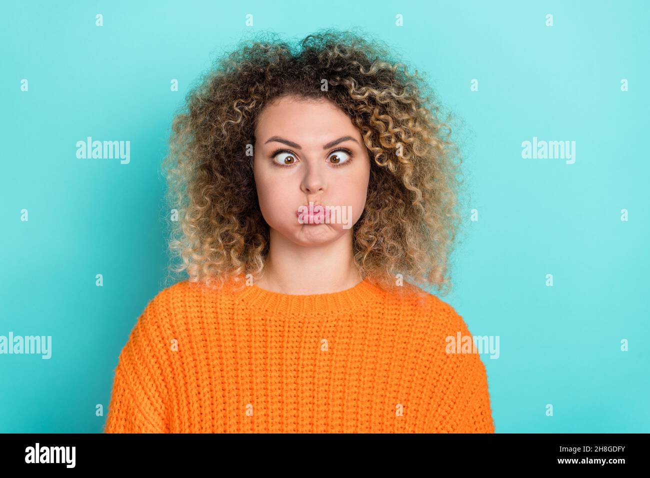 Photo of crazy foolish lady crossed eyes inflate cheeks wear orange ...