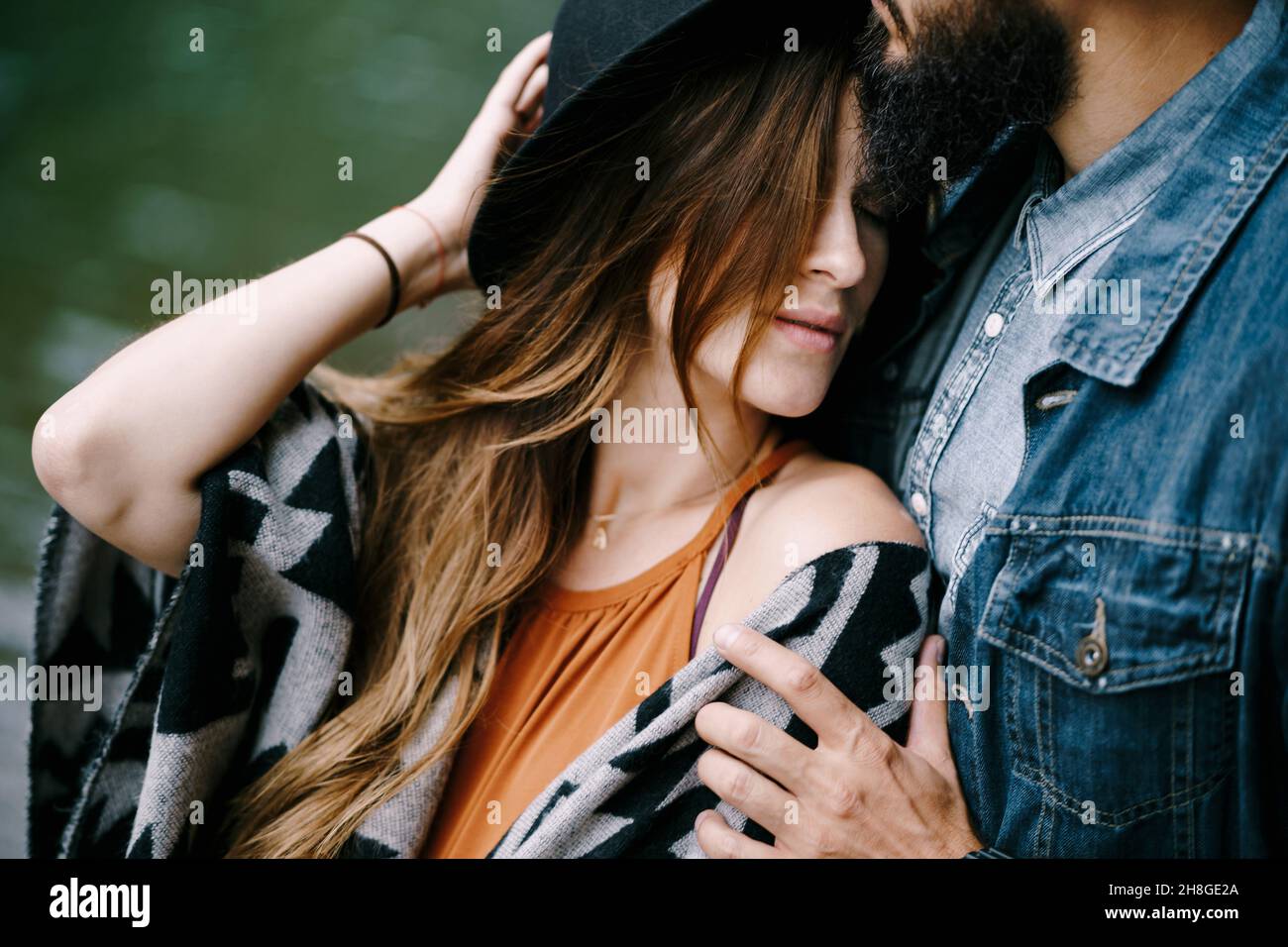 Man hugs the shoulders of a woman in hat. Portrait Stock Photo - Alamy