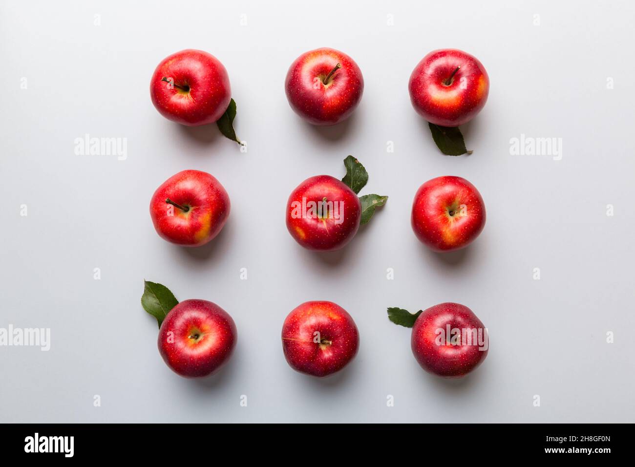 Many red apples on colored background, top view. Autumn pattern with ...